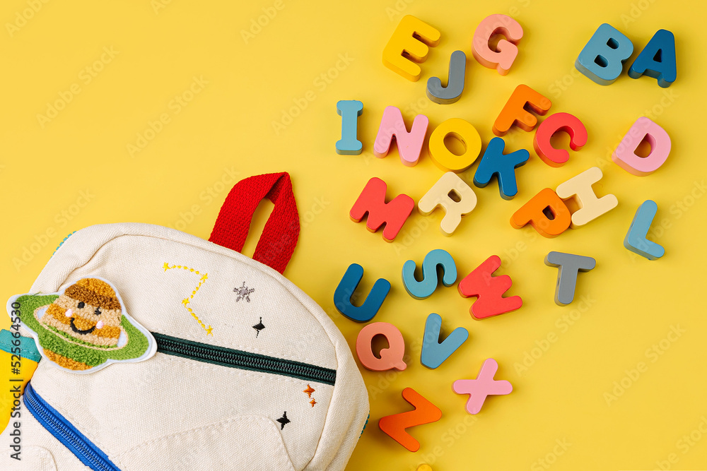 Opened Kids backpack with letters of the alphabet. Primary school or ...