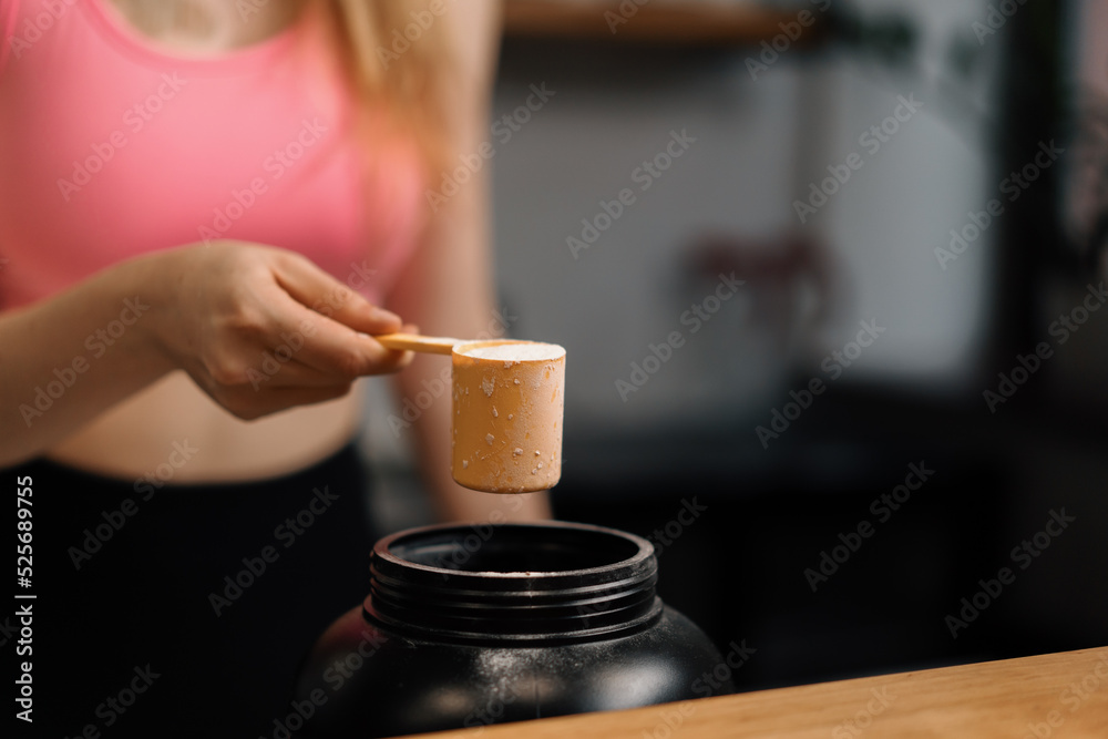 Curvy women make a protein shake at the fitness health bar in the gym ...
