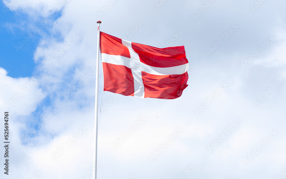 flag of denmark in a blue sky with clouds Stock Photo | Adobe Stock