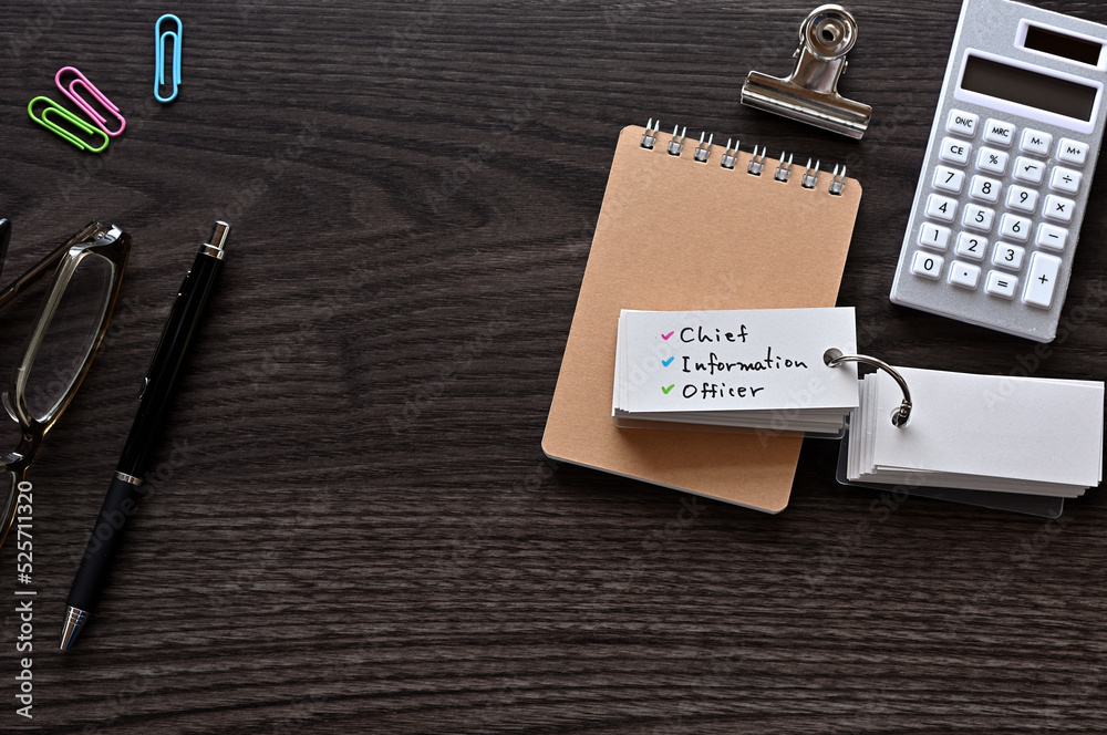 There is word card with the word chief information officer on the desk ...