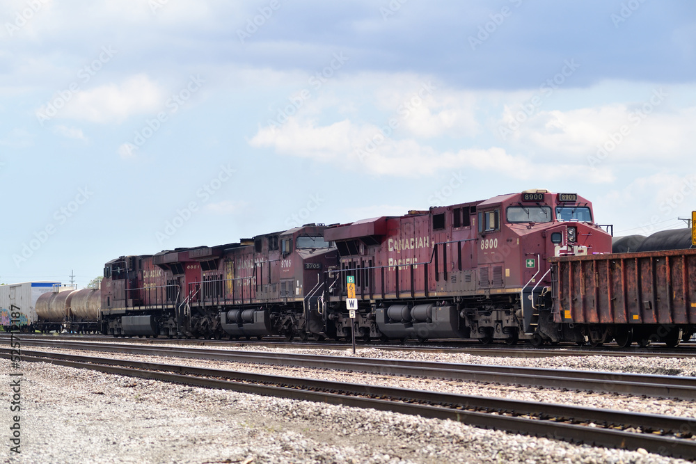 Inbound and outbound freight trains pass each other near the entrance ...