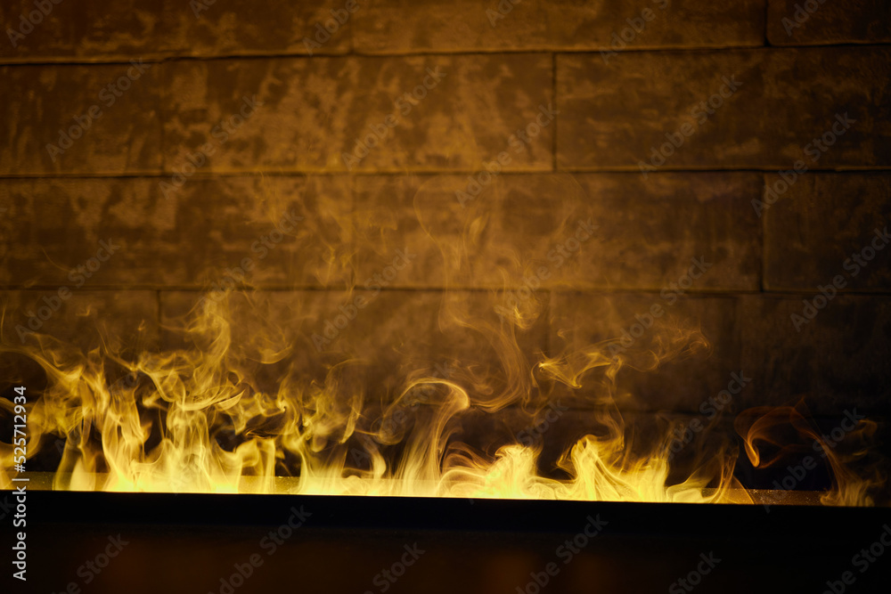 Side view on electric fireplace with artificial sparkling flame, decor ...