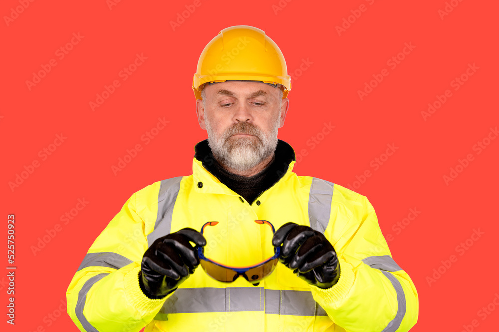 A construction worker in the yellow helmet, yellow hi-viz coat ready to ...
