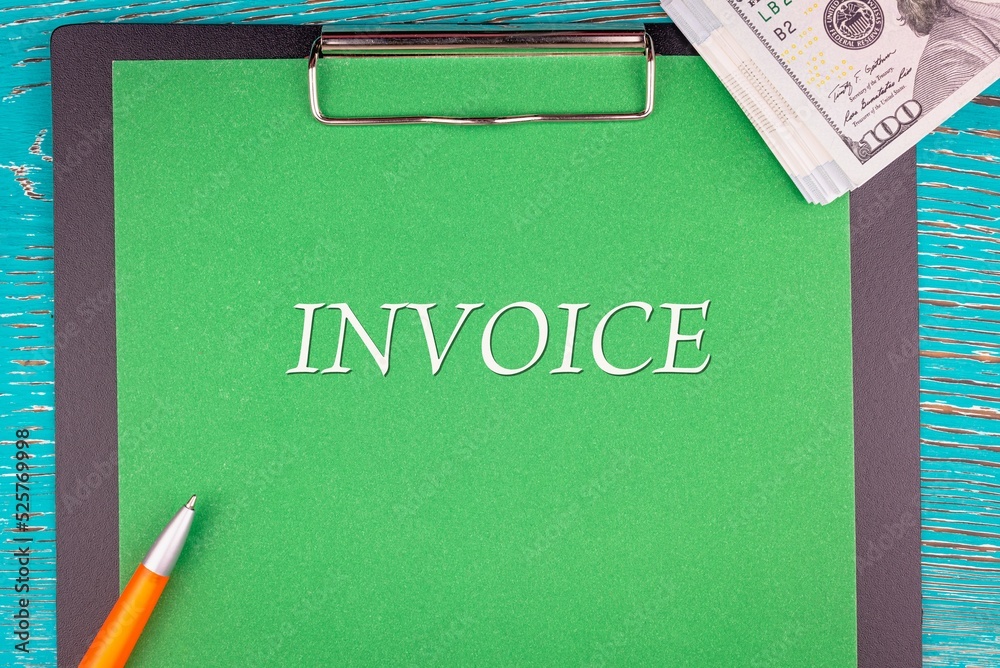 INVOICE - word (text) and money a pack of dollar bills on a green ...