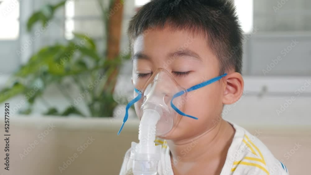 Asian Child using nebulizer mask equipment alone have smoke, Kid boy ...