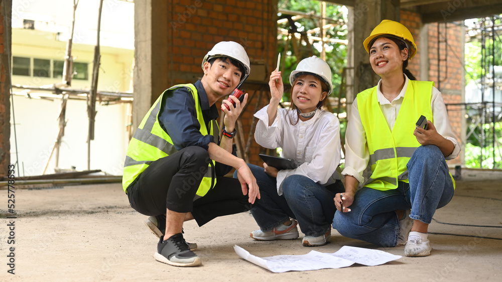 Civil engineers team wearing safety helmets and vests inspecting ...