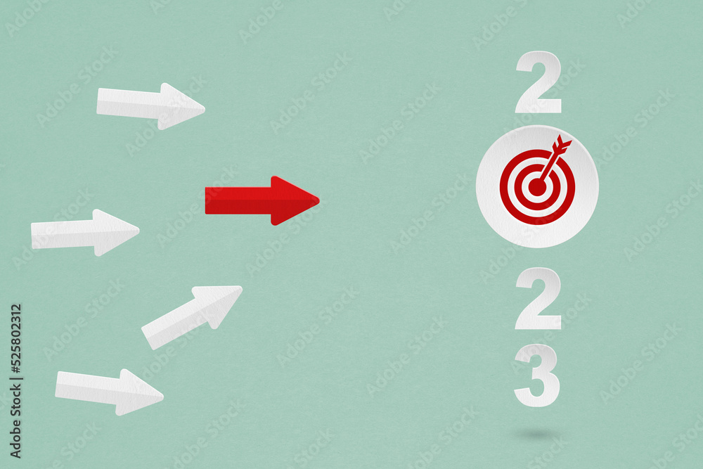 2023 year with target dartboard paper cut and leading red arrow for ...