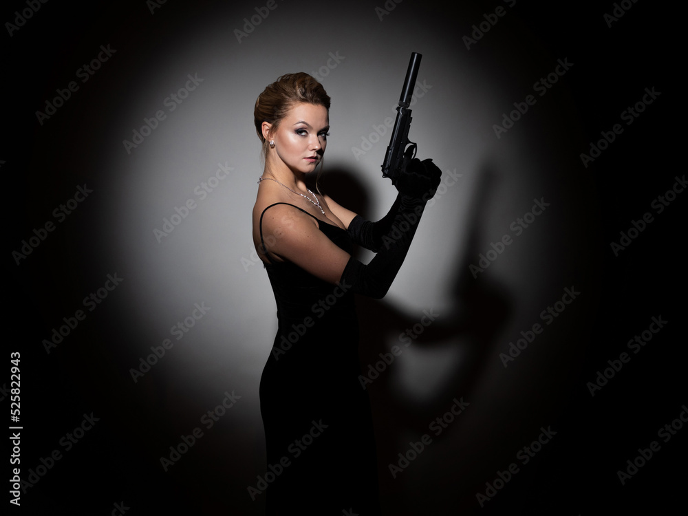 A dangerous spy. A femme fatale in a black dress with an open back ...