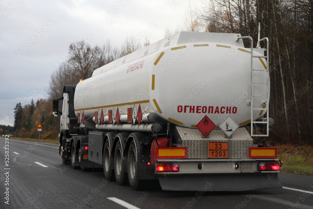 White semi truck Petrol fuel tanker with ADR 33 1203 dangerous class ...