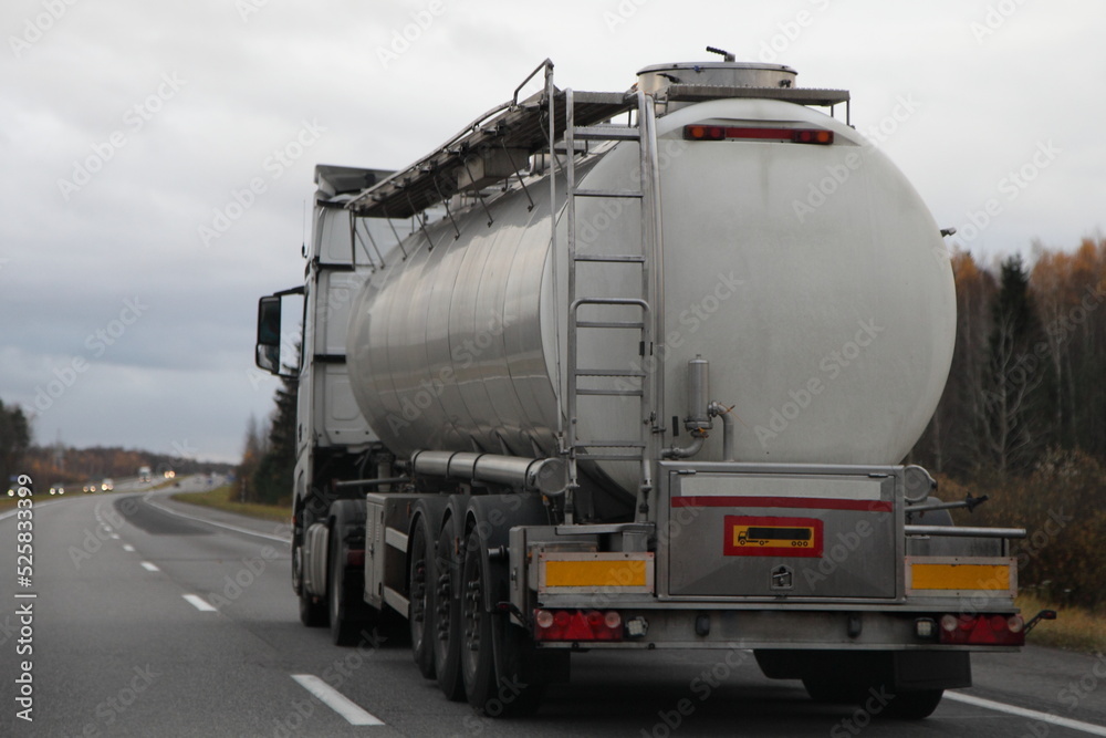 Old semi truck food barrel move on suburban highway road at autumn ...