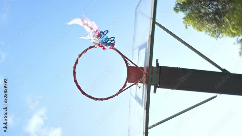 Zoom out camera movement with 360° roll effect shows a basketball hoop ...