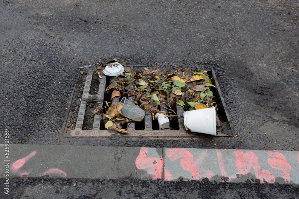 trash blocking storm drain gutter graffiti Stock Photo | Adobe Stock