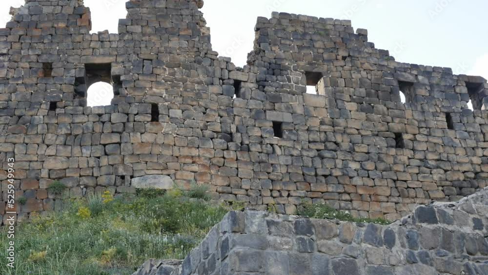 the walls of the ancient castle built of stones are partially destroyed ...
