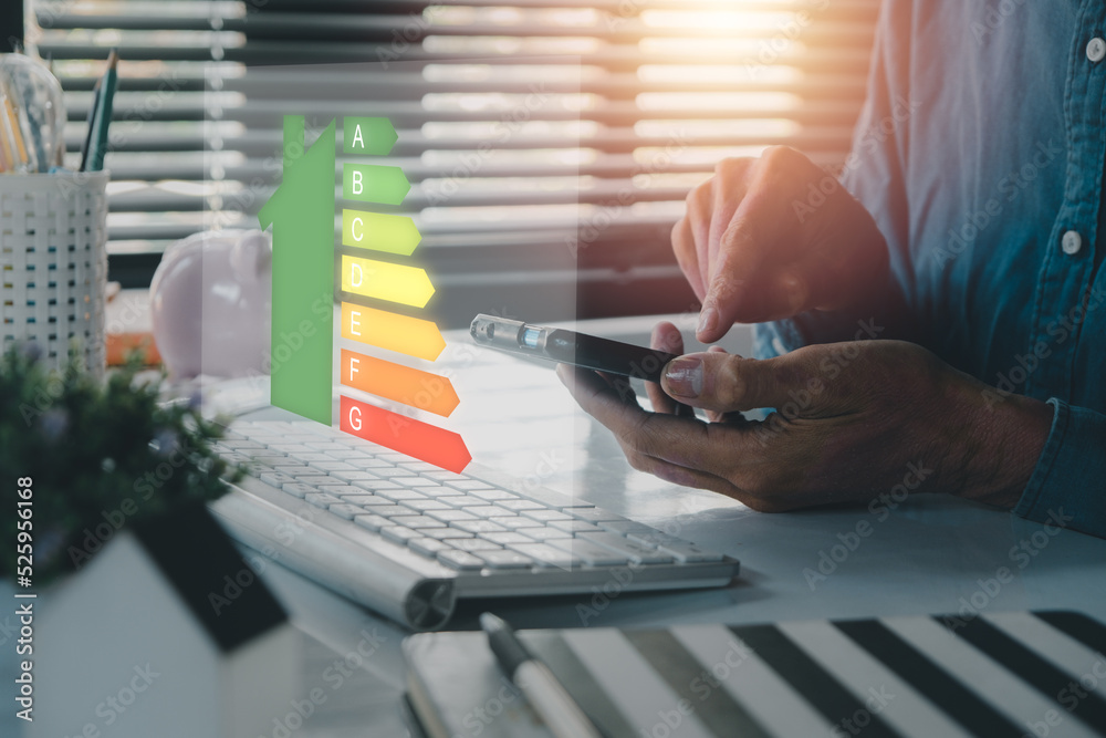 Person hand using laptop computer with house icon energy efficiency ...