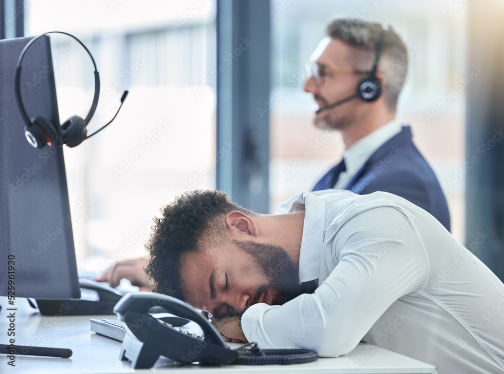 Lazy, sleeping and tired call center agent at his table or desk at work ...