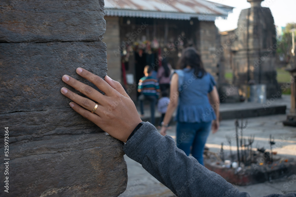 Hand of a woman on the wall of ancient Hindu temple showing procession ...