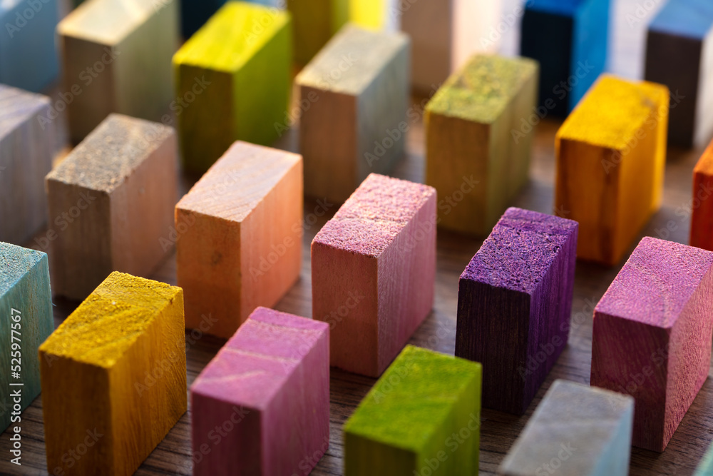 Spectrum of colorful wooden blocks aligned on a rustic old wood table ...