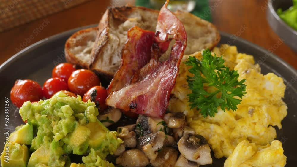 Simple and tasty breakfast, close up dolly shot of plate with pan-fried ...