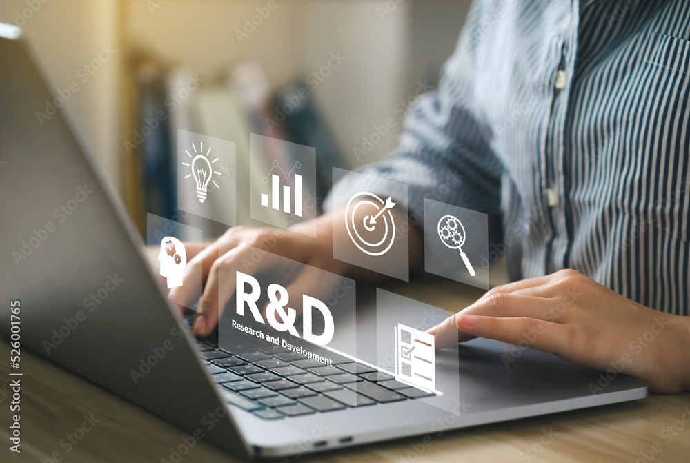Women use a computer with the R and D icon for Research and Development ...