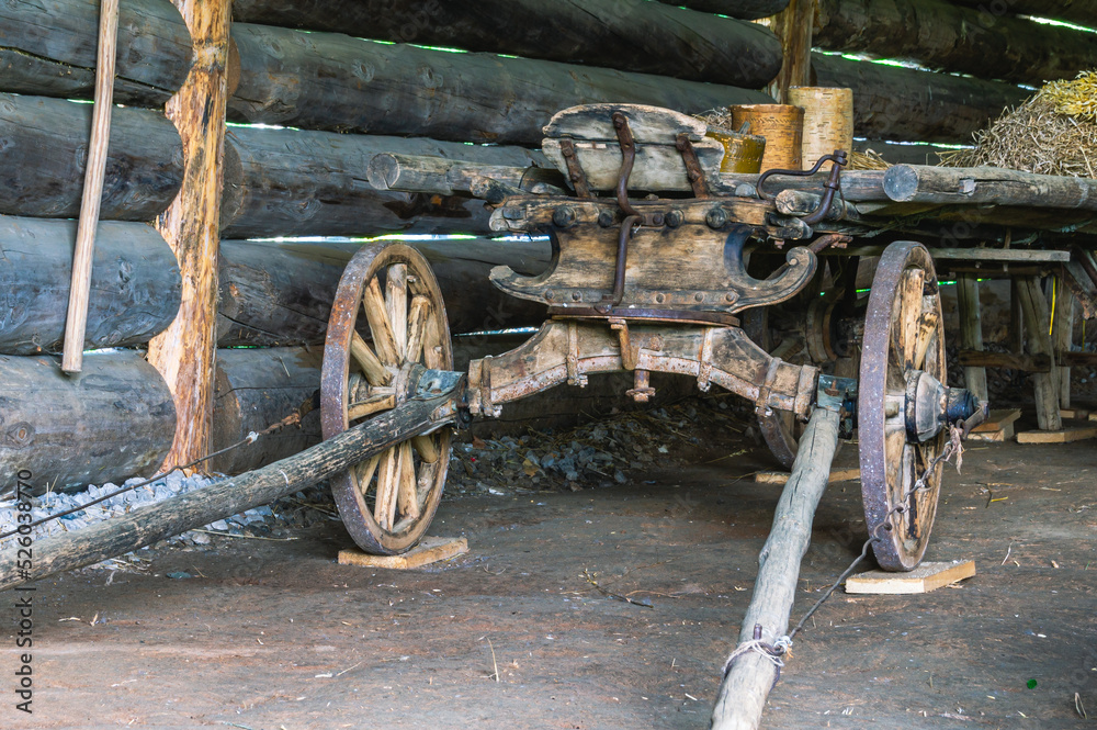 The cart is in the shed for drying and threshing sheaves. A log barn in ...