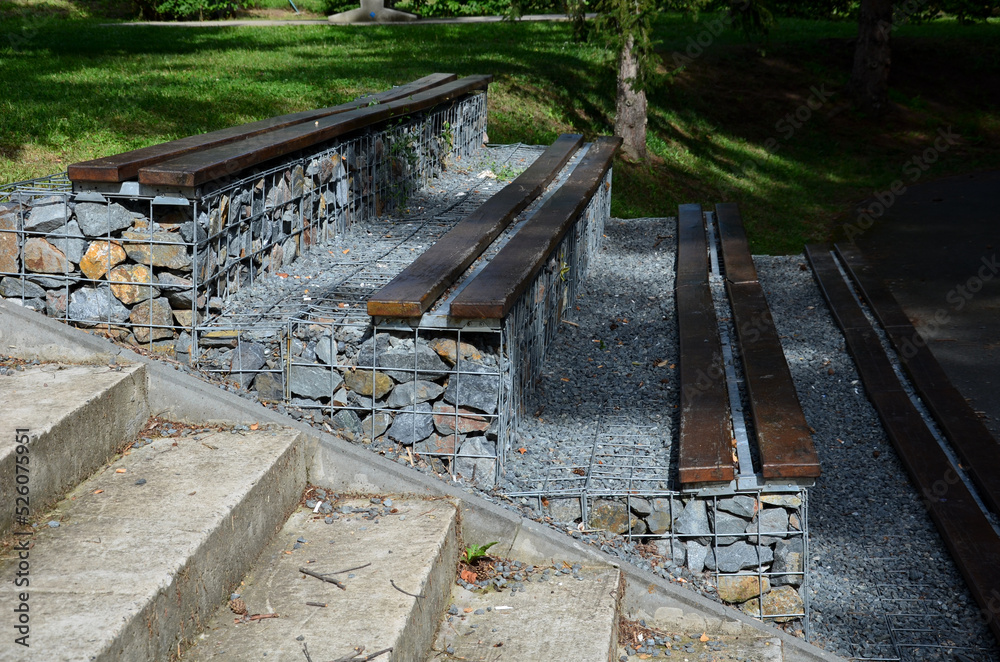 grandstand in the park by a concrete staircase made of gabion baskets ...