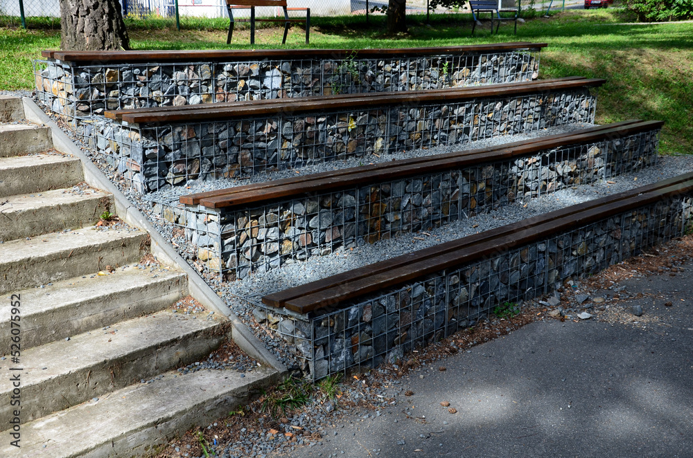 grandstand in the park by a concrete staircase made of gabion baskets ...