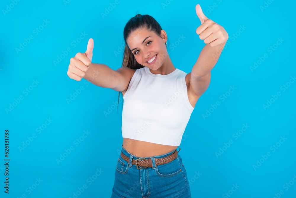 Beautiful Brunette Woman Wearing White Tank Top Over Blue Background
