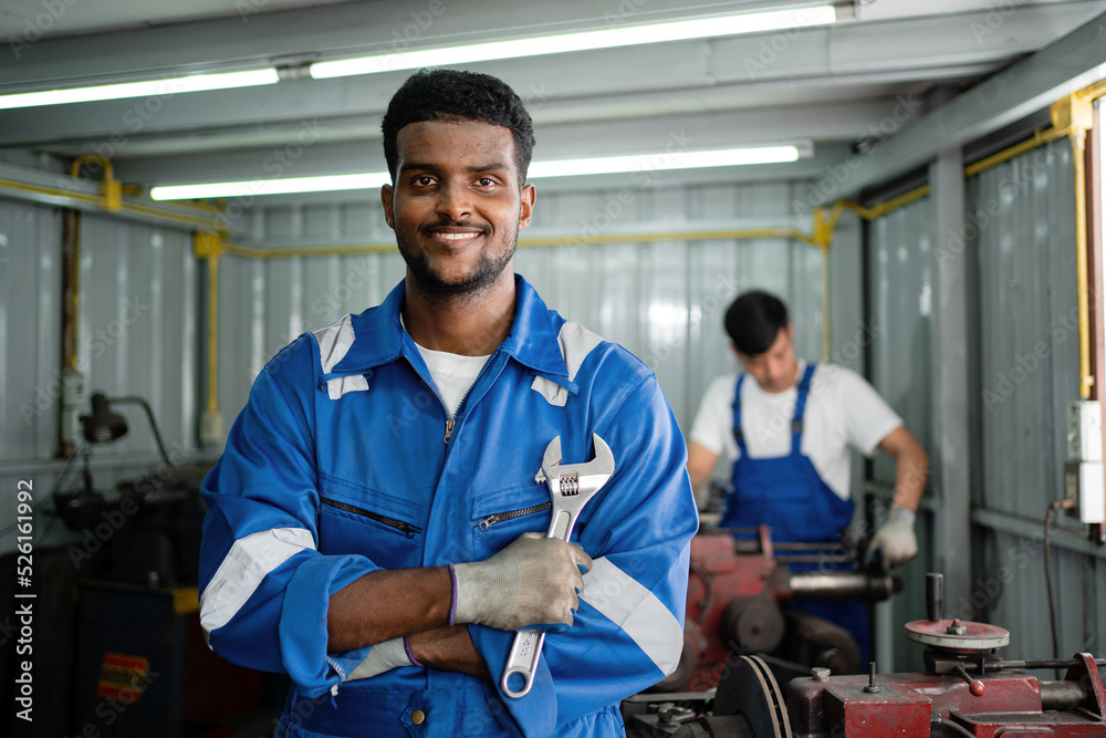 Portrait of a smiling black male engineer working in an industrial ...