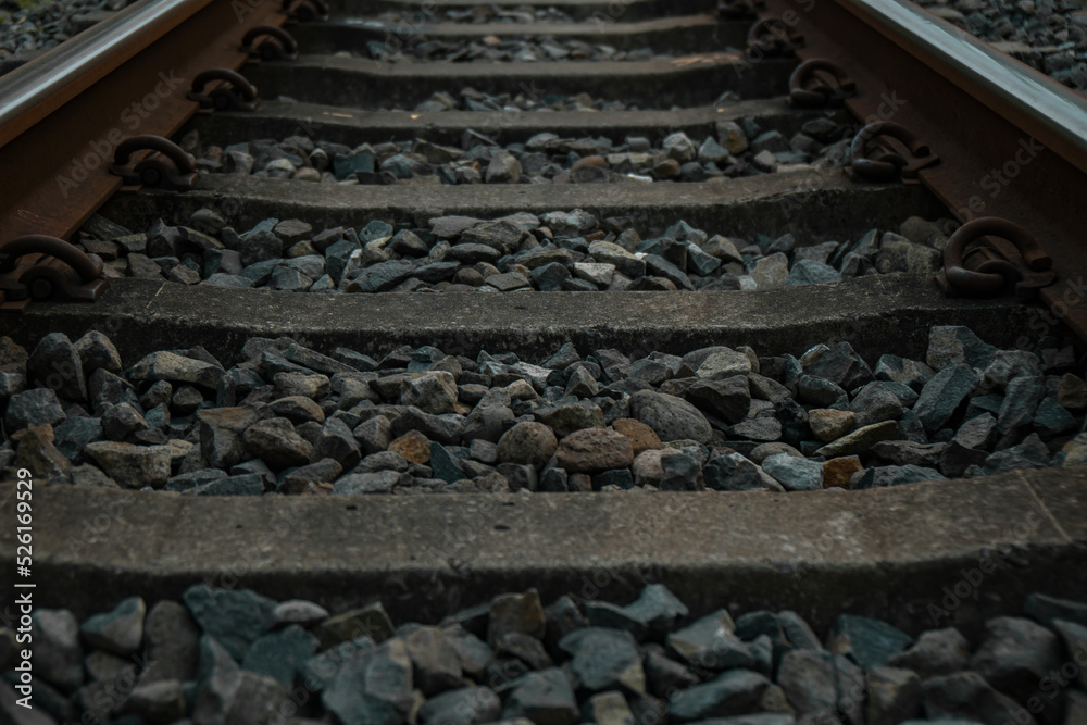 Details of the railroad track made of iron, wood and gravel in a ...