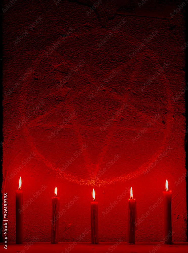 White pentagram symbol on concrete wall. Satanic altar illuminated with ...