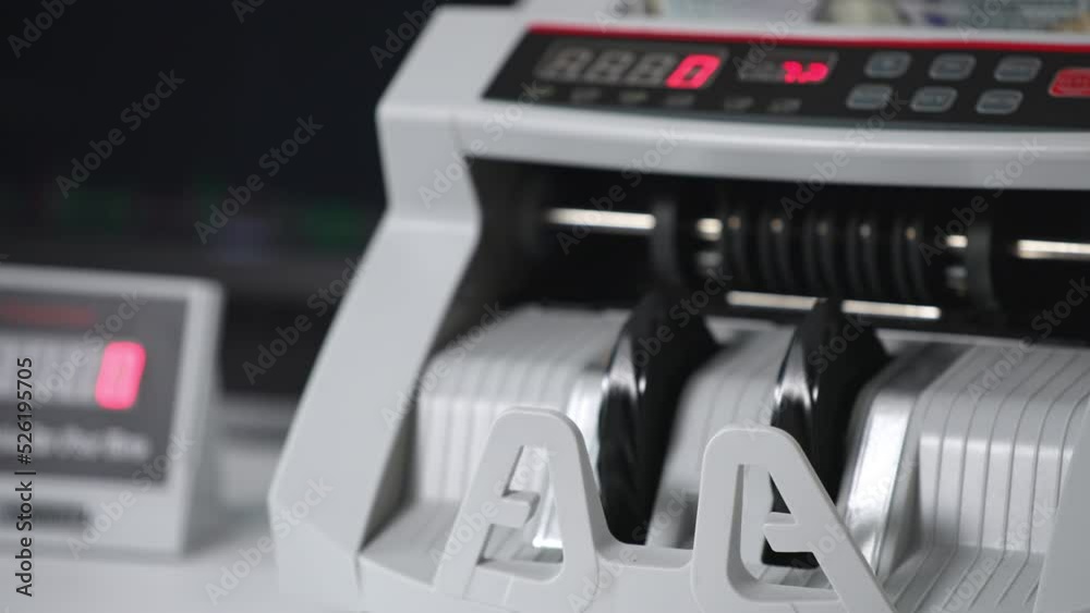 Cash counting machine switched on and the rollers begin to rotate. A ...