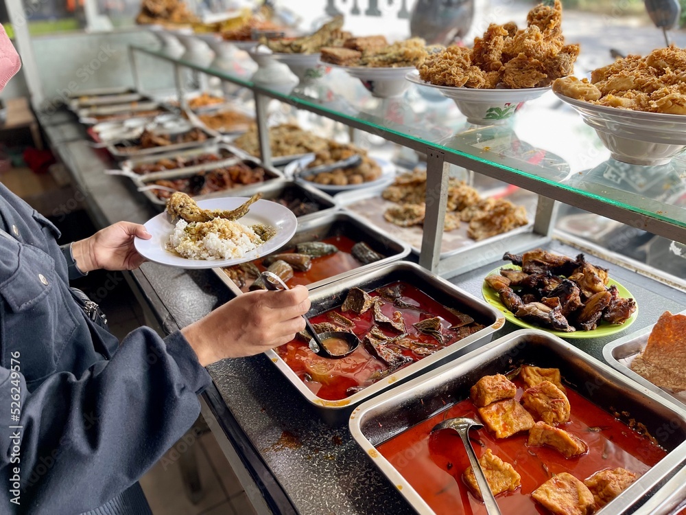 Padang food stalls share a variety of buffet menus with vegetables ...