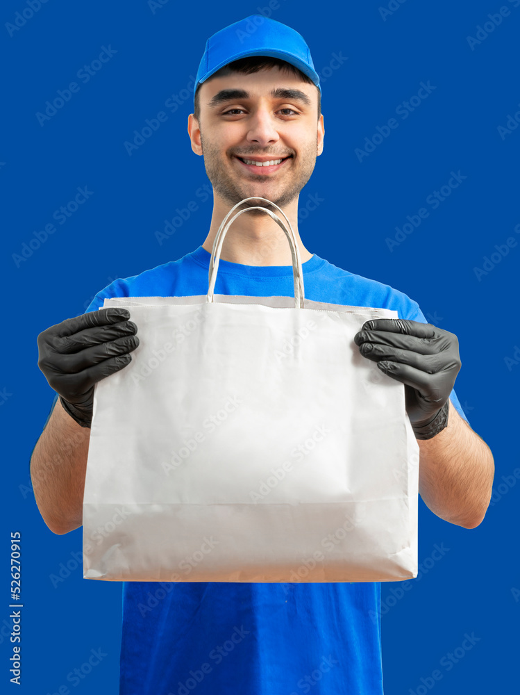 Delivery man with paper bag. Courier in uniform cap and t-shirt, gloves ...