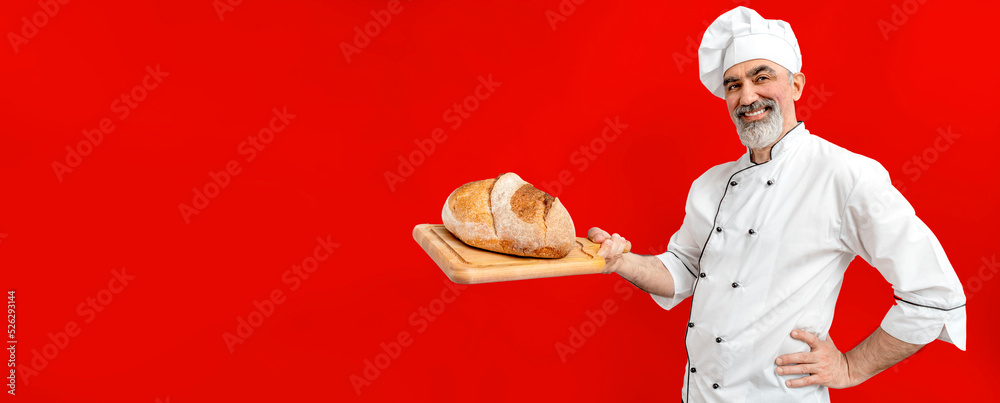 Chef-cooker in chef's hat and jacket working in bakery, holding French ...
