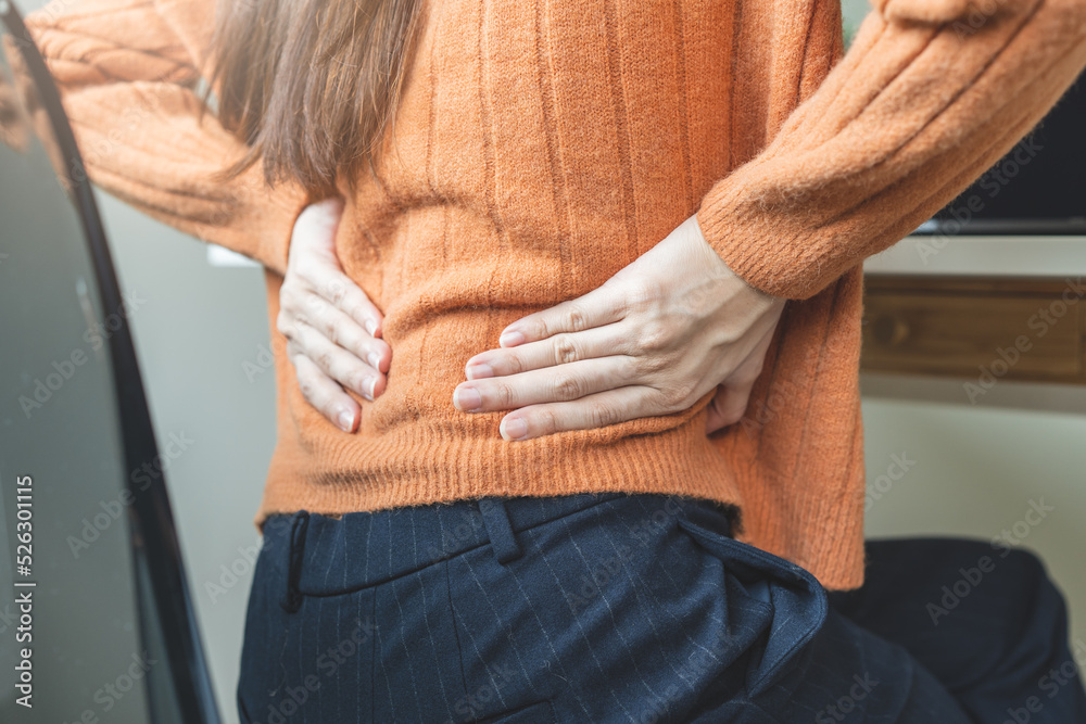 office syndrome, woman with back pain symptoms during work in the ...