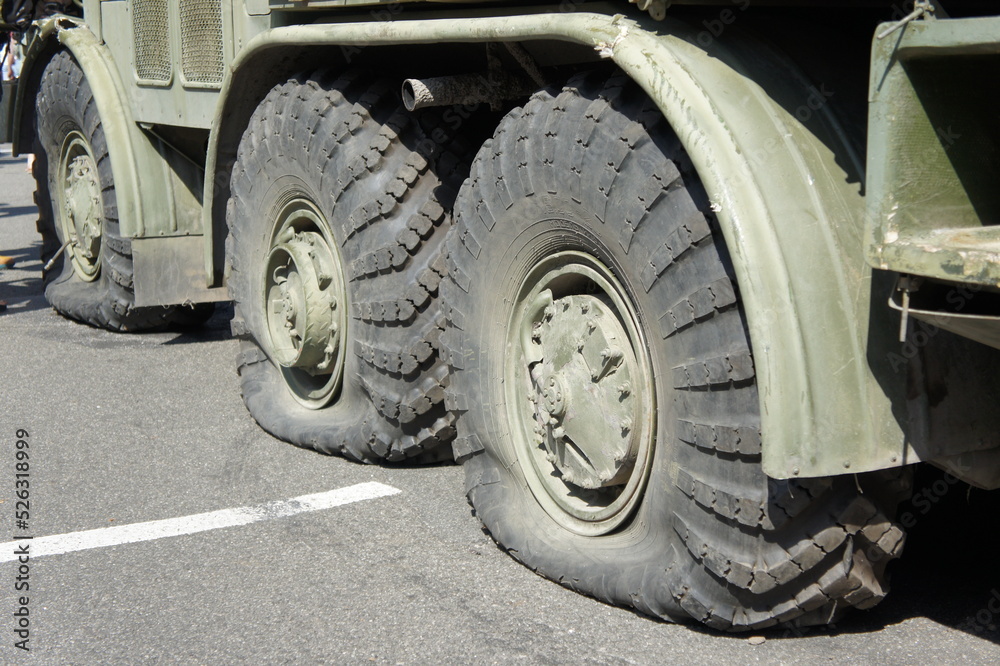 A punctured and flat tire of military equipment of the armored ...