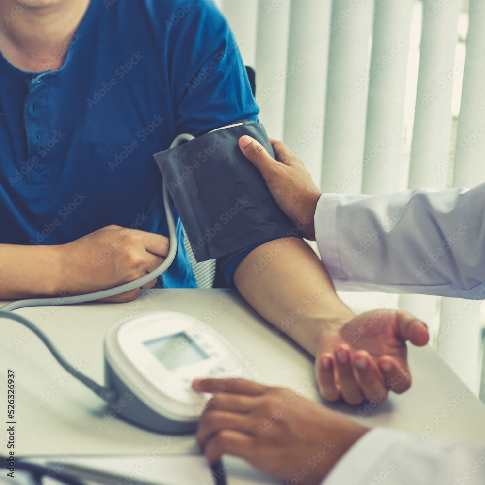 Female doctors use blood pressure monitors and stethoscope to measure ...