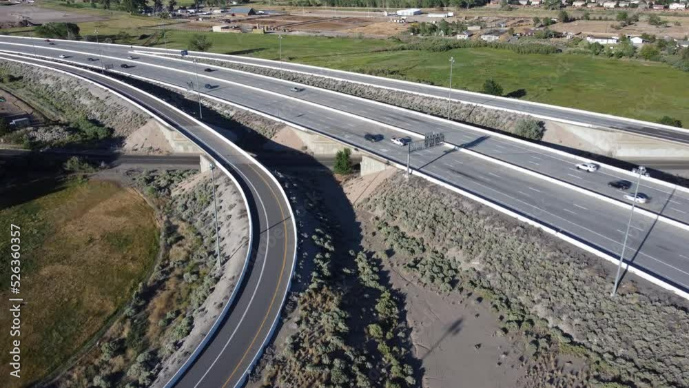 Flight forward and hover freeway north south and exit ramp with traffic ...