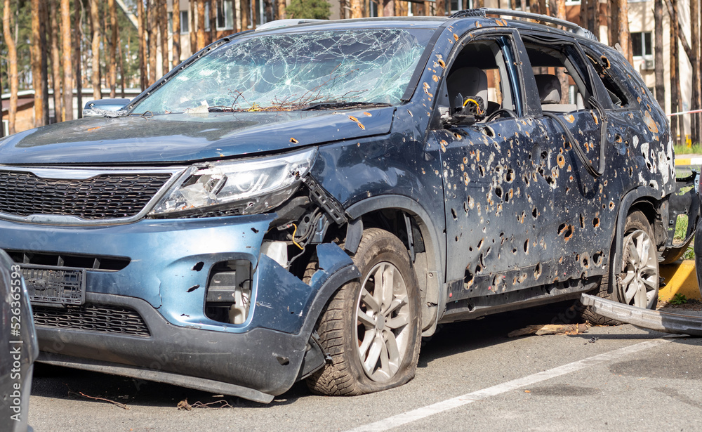 Car riddled with bullets. War of Russia against Ukraine. A car of ...