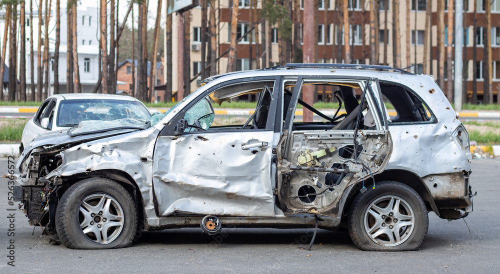 Car riddled with bullets. War of Russia against Ukraine. A car of ...
