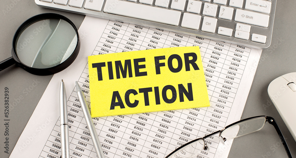 TIME TO ACTION text written on a sticky on chart with keyboard and ...