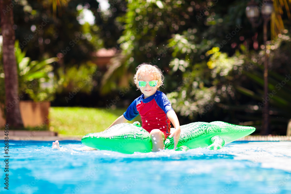 Child in swimming pool. Kid on inflatable float Stock Photo | Adobe Stock