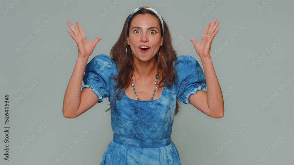 Excited amazed young woman touching her head and showing explosion ...