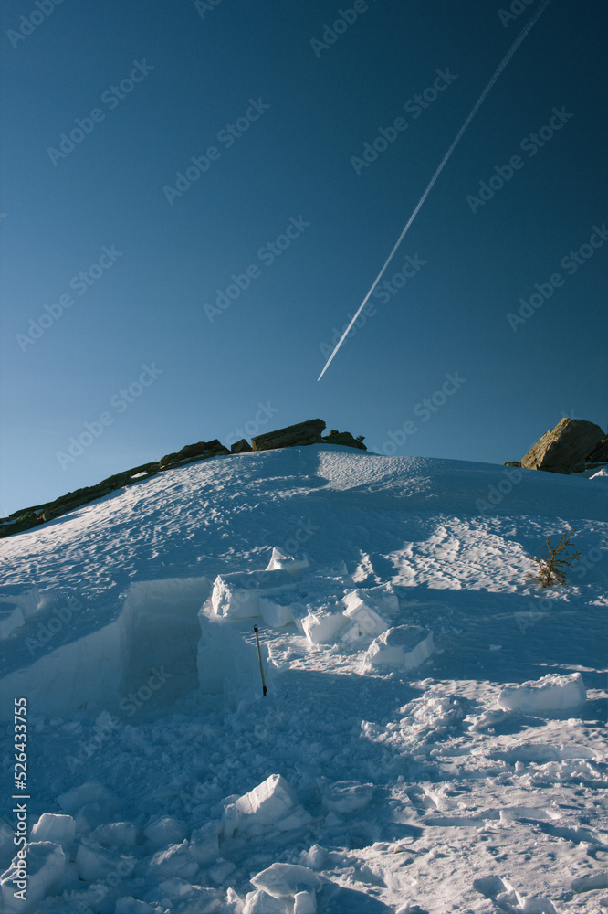 The initial stage of digging a snow cave on a mountain snow-covered ...