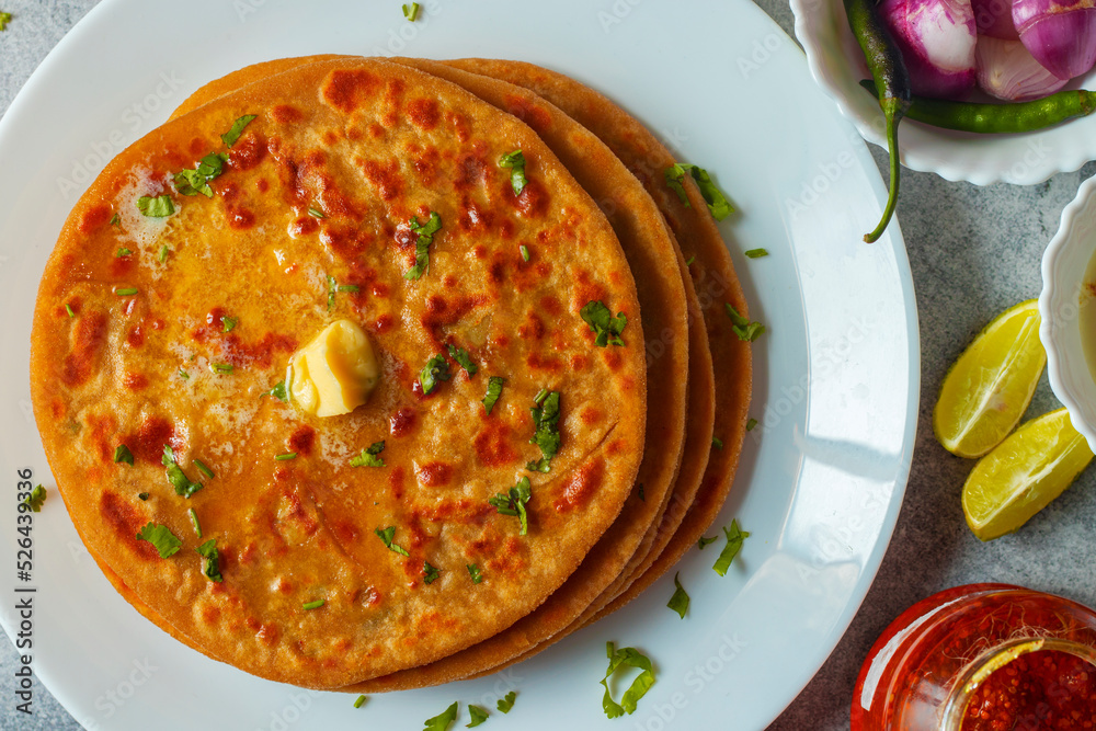 North Indian famous food Aloo Paratha with mango pickle and butter ...