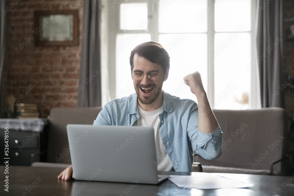 Excited millennial freelance business man getting good news message ...
