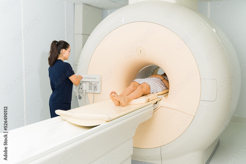 Young woman at the MRI machine getting a brain resonance Stock Photo ...