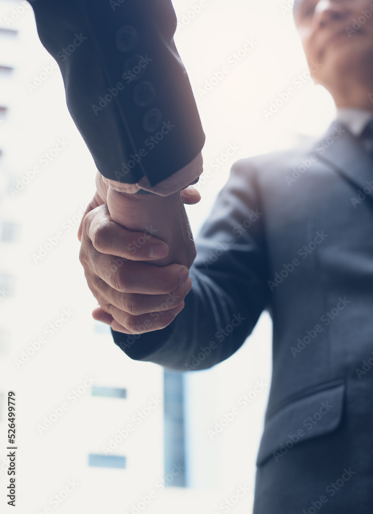 Businessmen making handshake in the city, business etiquette ...
