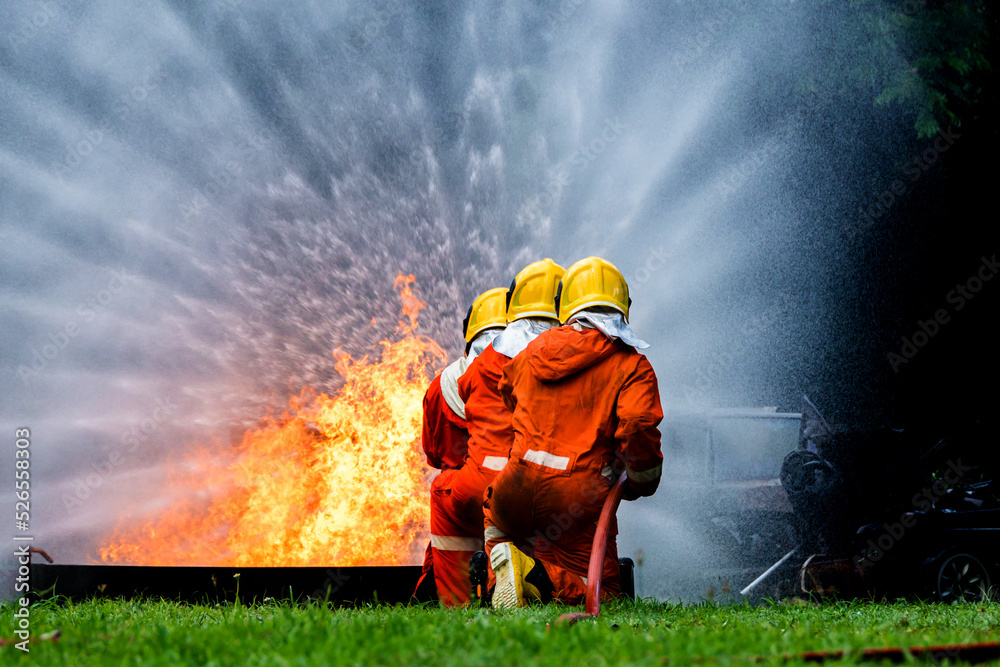 Firefighter Concept. Fireman using water and extinguisher to fighting ...