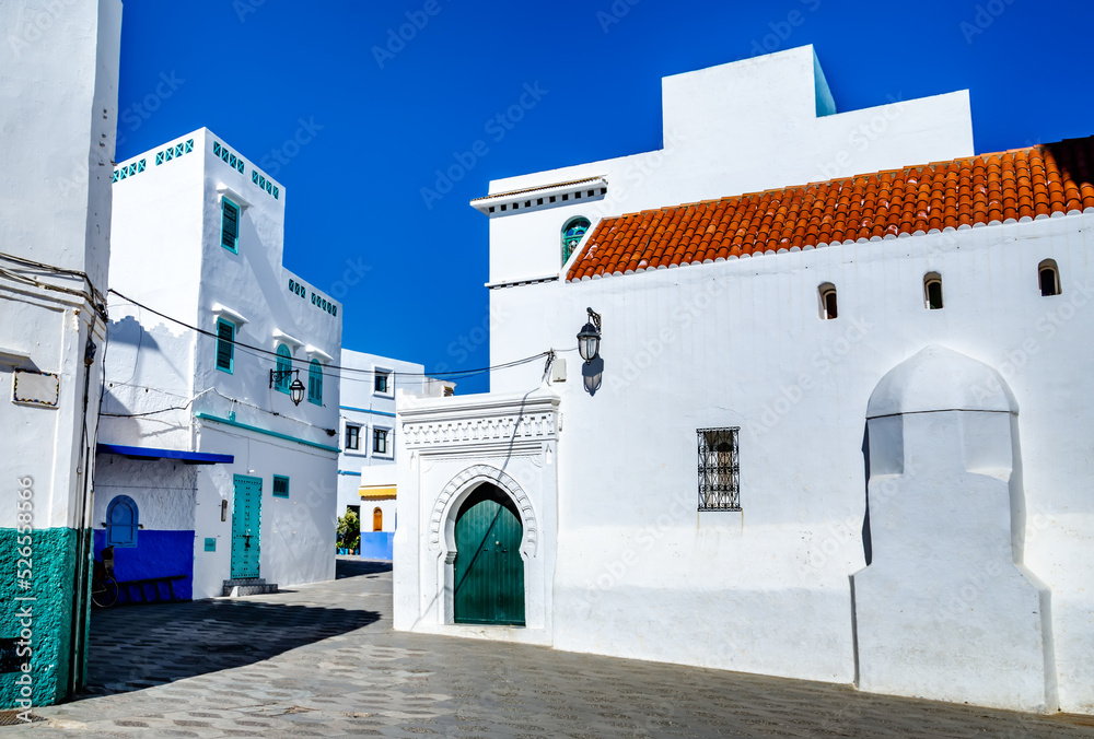 Beautiful view of street with typical arabic architecture in Asilah ...